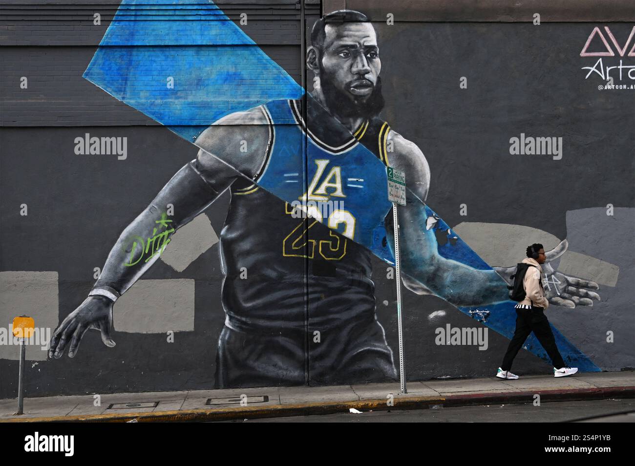 Passers-by in front of a large LeBron James mural, Hollywood, Los ...
