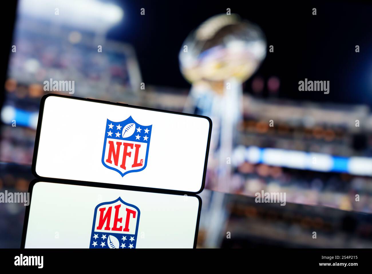 A smartphone displaying the NFL logo with a blurred Super bowl ...
