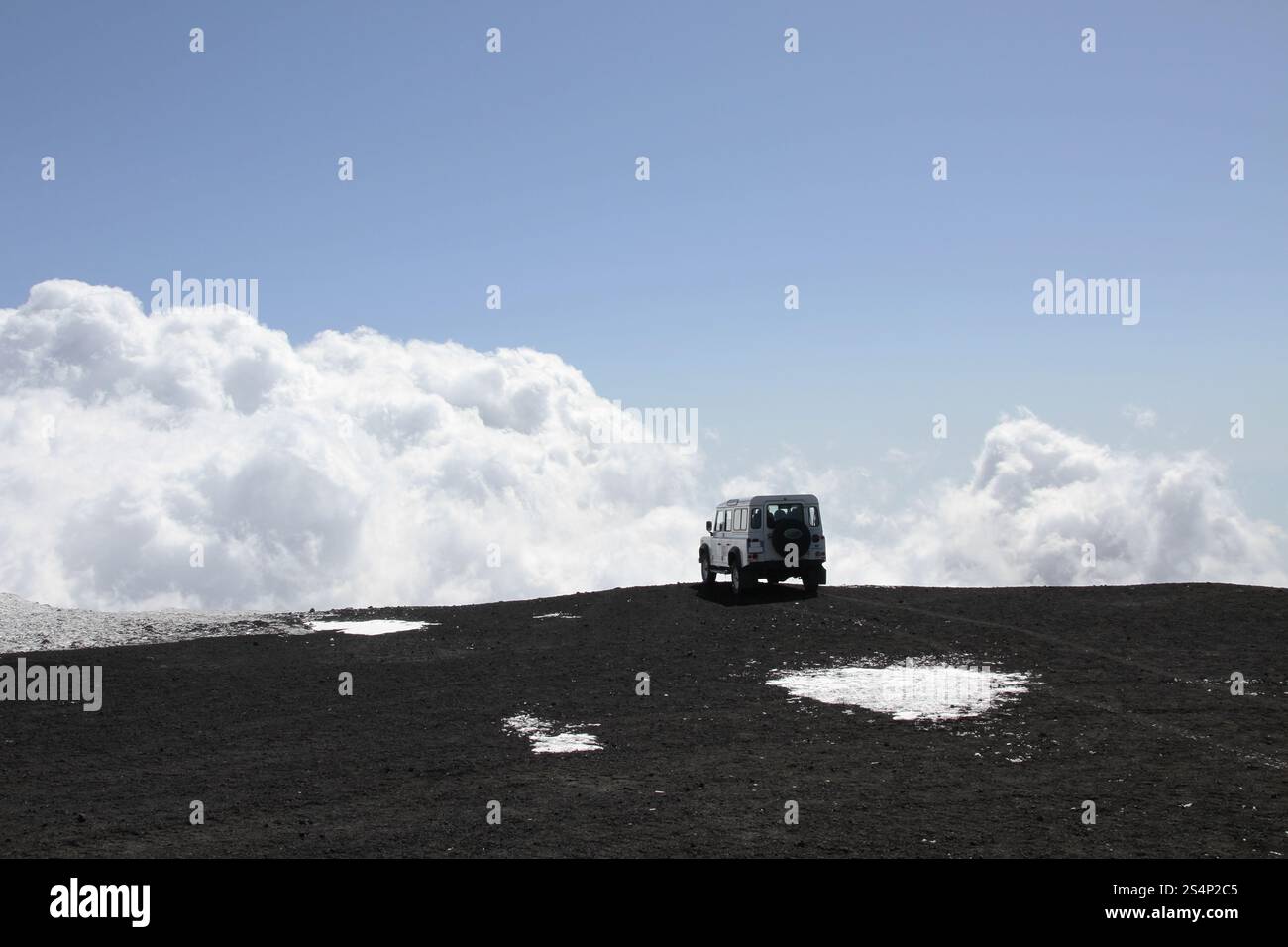 4x4 Vehicle on lava and snow at the top of Mt Etna volcano - clouds ...
