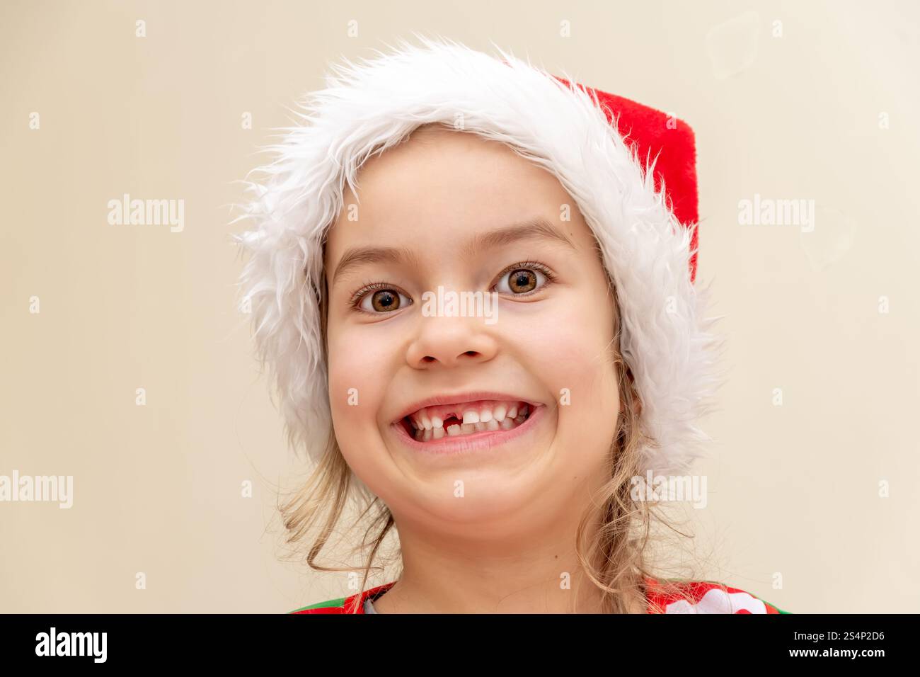 A happy 6-year-old girl in a New Year's outfit with a wide toothless smile Stock Photo - Alamy