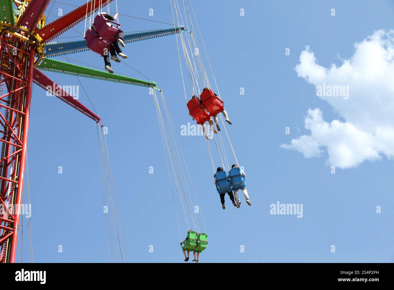 Colored carousel in an amusement park against blue sky Stock Photo - Alamy