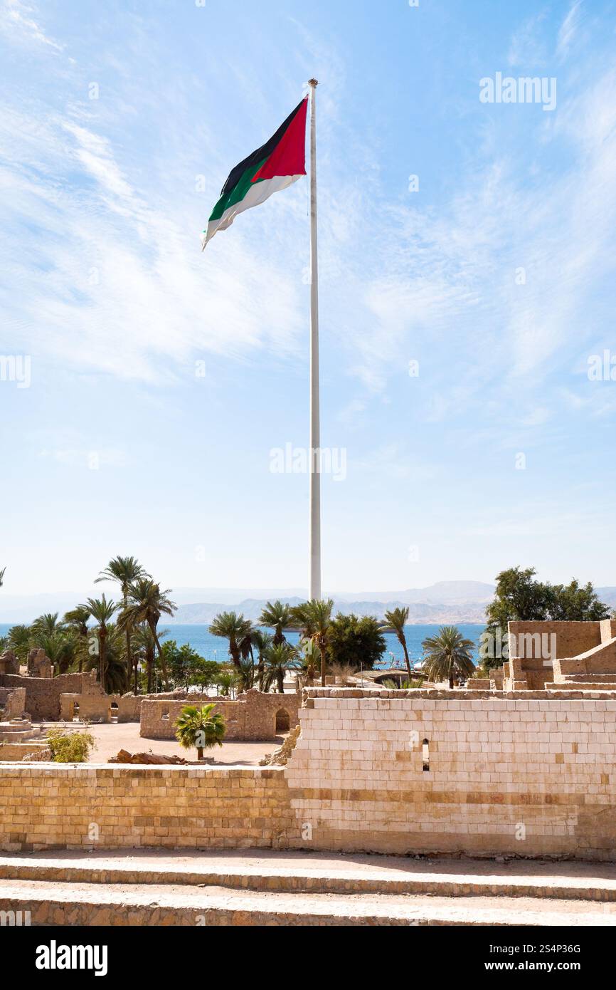 The Aqaba Flagpole under ruins of medieval Mamluks Aqaba fort Stock ...
