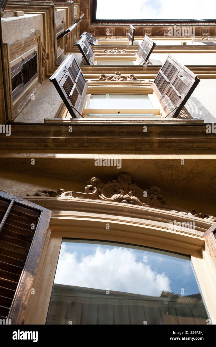 four windows with open shutters Stock Photo - Alamy