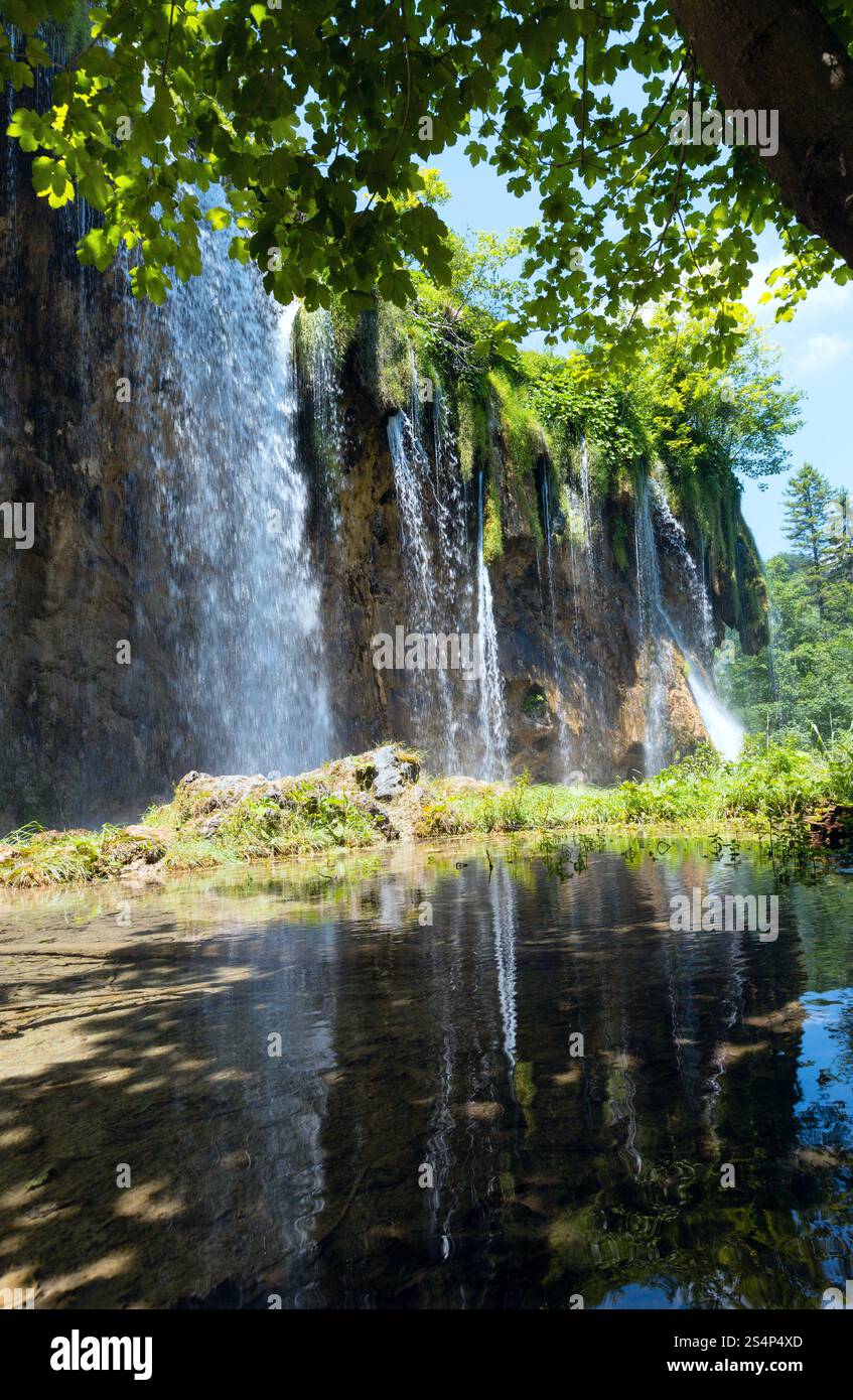 Waterfall reflection in small clear transparent lake (Plitvice Lakes ...