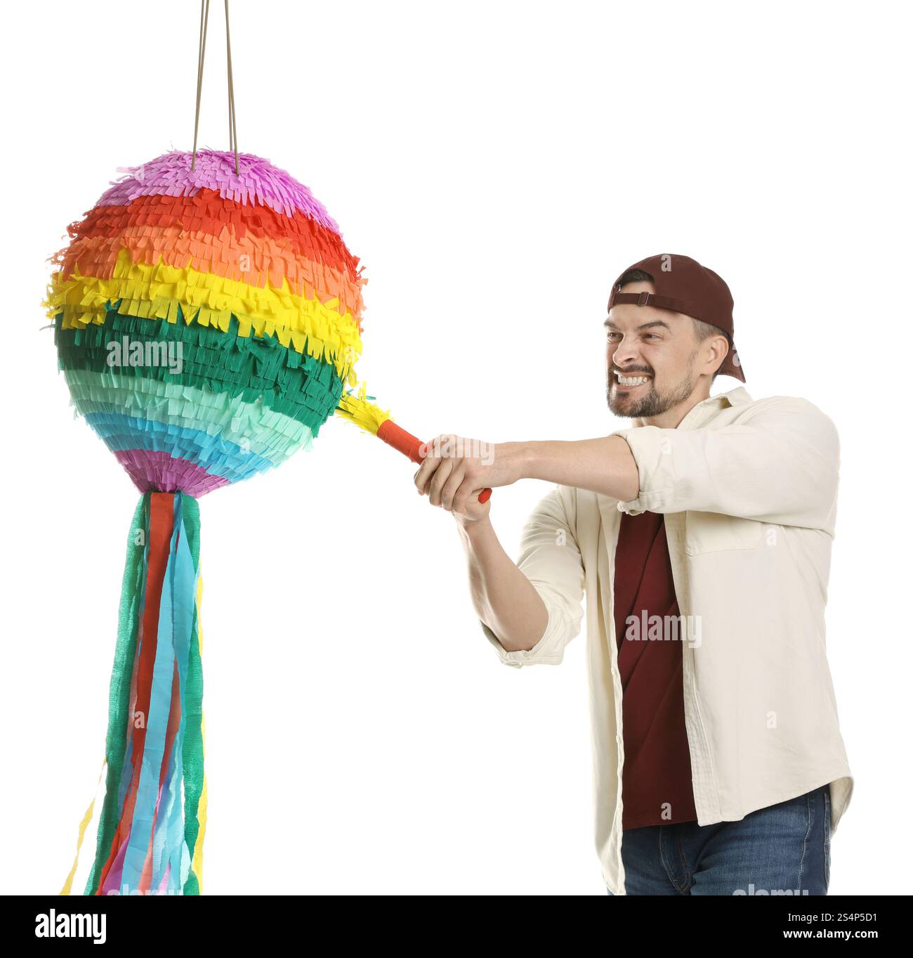 Happy man hitting colorful pinata with stick on white background Stock ...