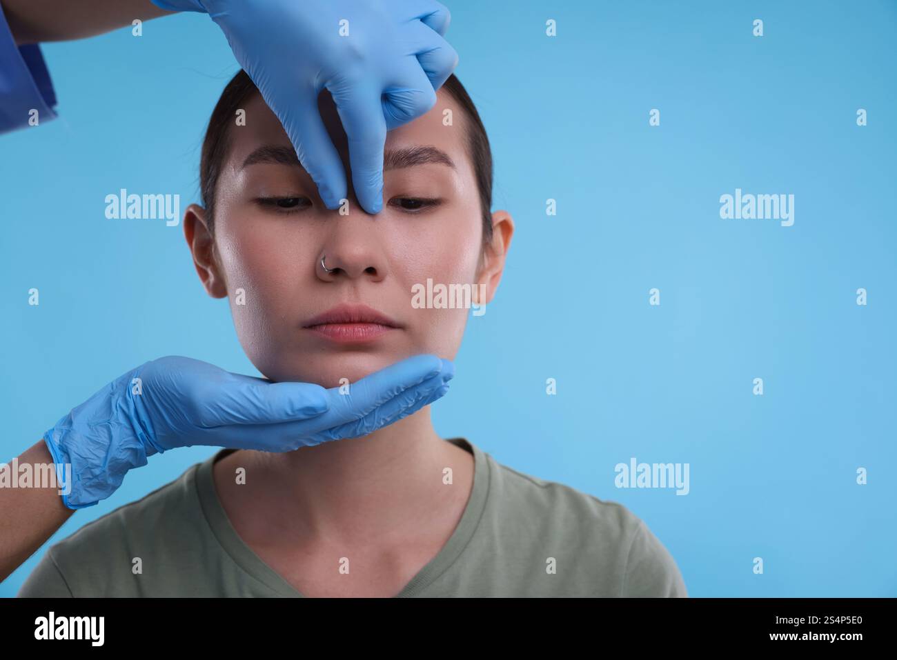 Doctor checking patient's nose before plastic surgery operation on ...