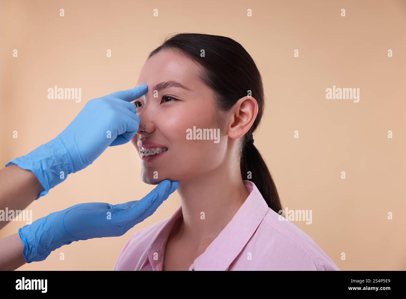 Doctor checking patient's nose before plastic surgery operation on ...