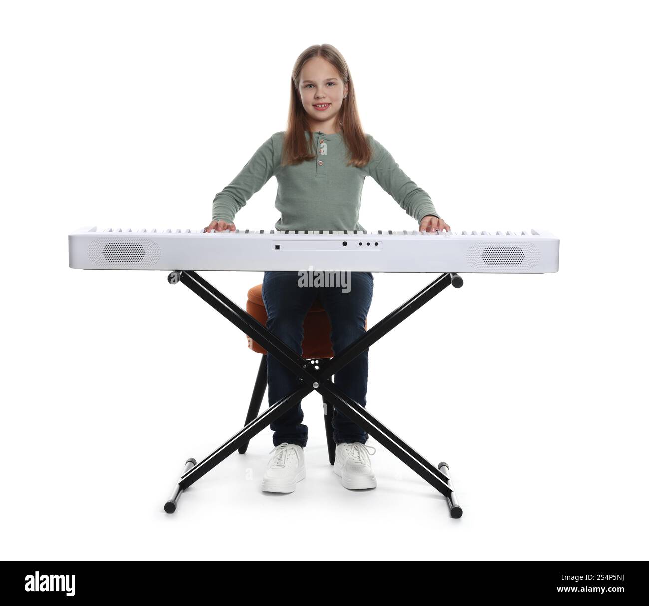 Cute girl playing synthesizer on white background Stock Photo - Alamy