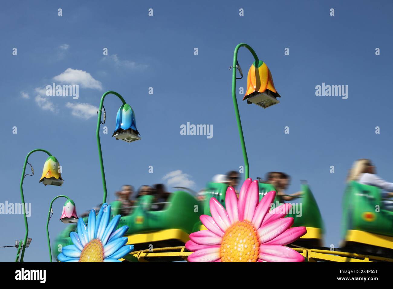 rollercoaster for childrens in an amusement park against blue sky ...