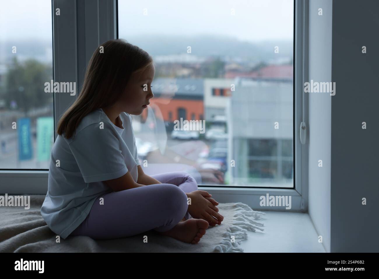 Autism concept. Lonely little girl near window at home Stock Photo - Alamy