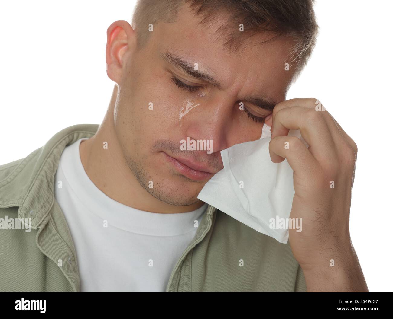 Crying man wiping tears with tissue on white background Stock Photo - Alamy