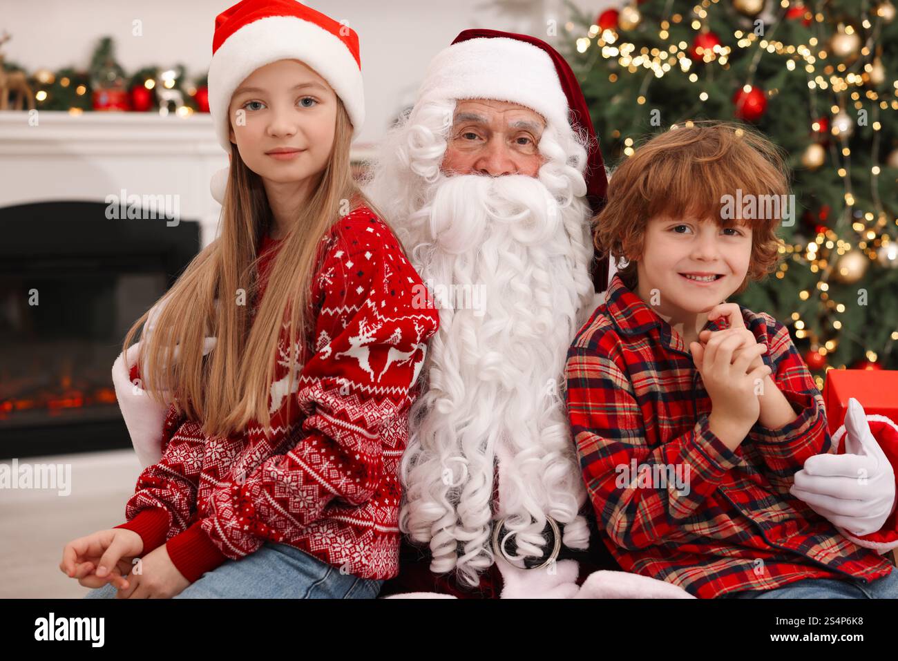 Christmas celebration. Santa Claus and kids at home Stock Photo - Alamy