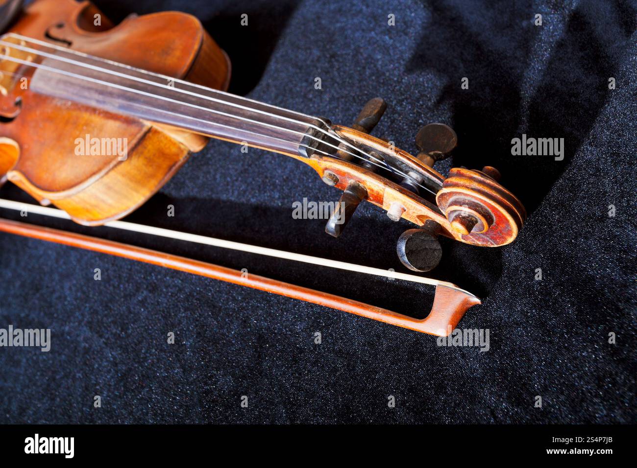 violin pegbox and bow on black velvet background close up Stock Photo ...