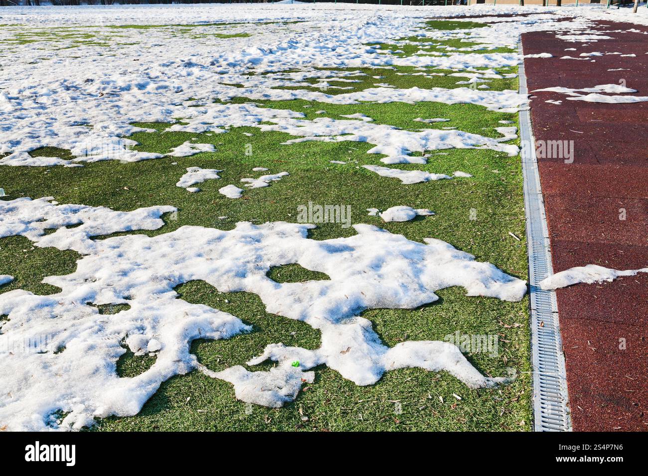snowdrifts on outdoor soccer field in spring low season Stock Photo - Alamy