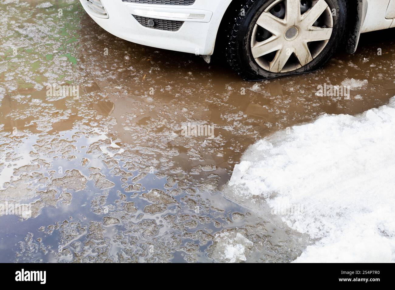 bad road condotions - car wheel in melting show puddle Stock Photo - Alamy
