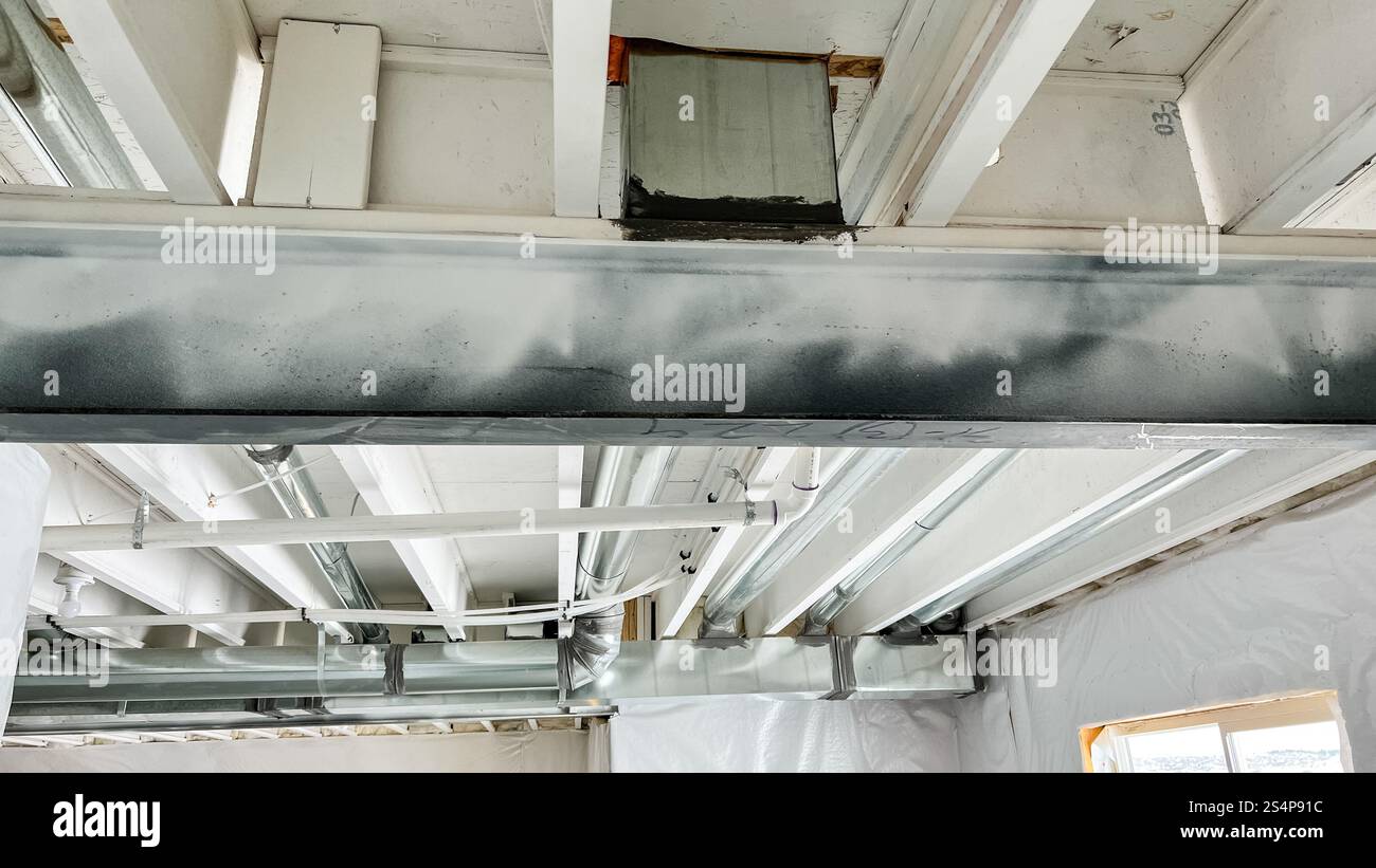 Exposed Metal Beam in Basement Construction Stock Photo - Alamy