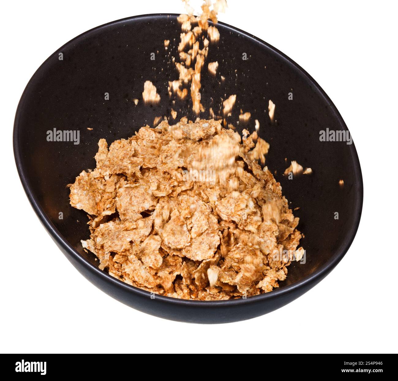 spilling of cereals in dark bowl isolated on white background Stock ...