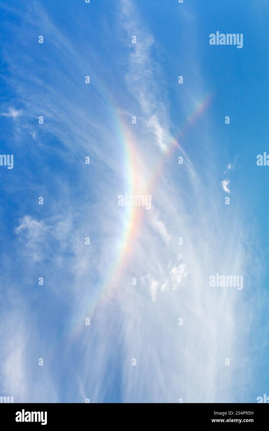 Rainbow in blue sky with white clouds hi-res stock photography and ...