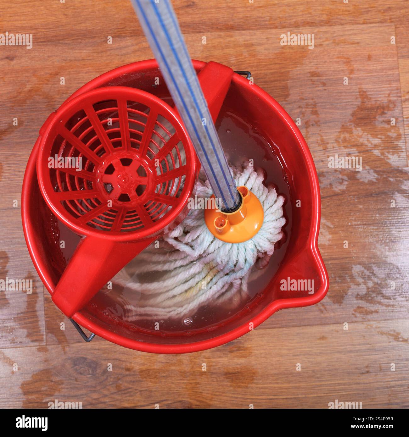 top view of textile mop in red bucket Stock Photo - Alamy