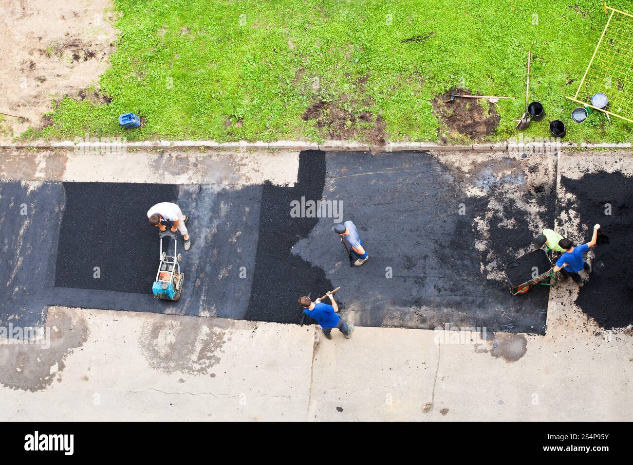 municipal roadmen laid asphalt on urban road Stock Photo - Alamy