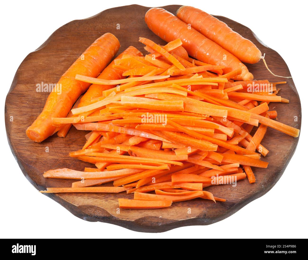 raw cleaned carrots and strips sliced carrot on wooden cutting board ...