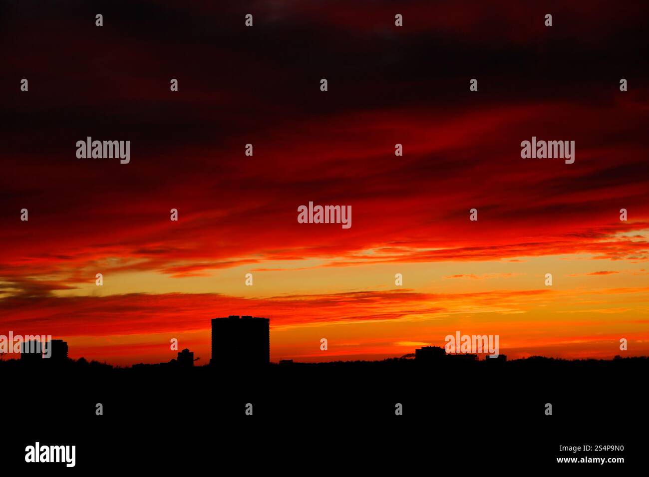 dramatic dark red sunrise sky over urban houses Stock Photo - Alamy