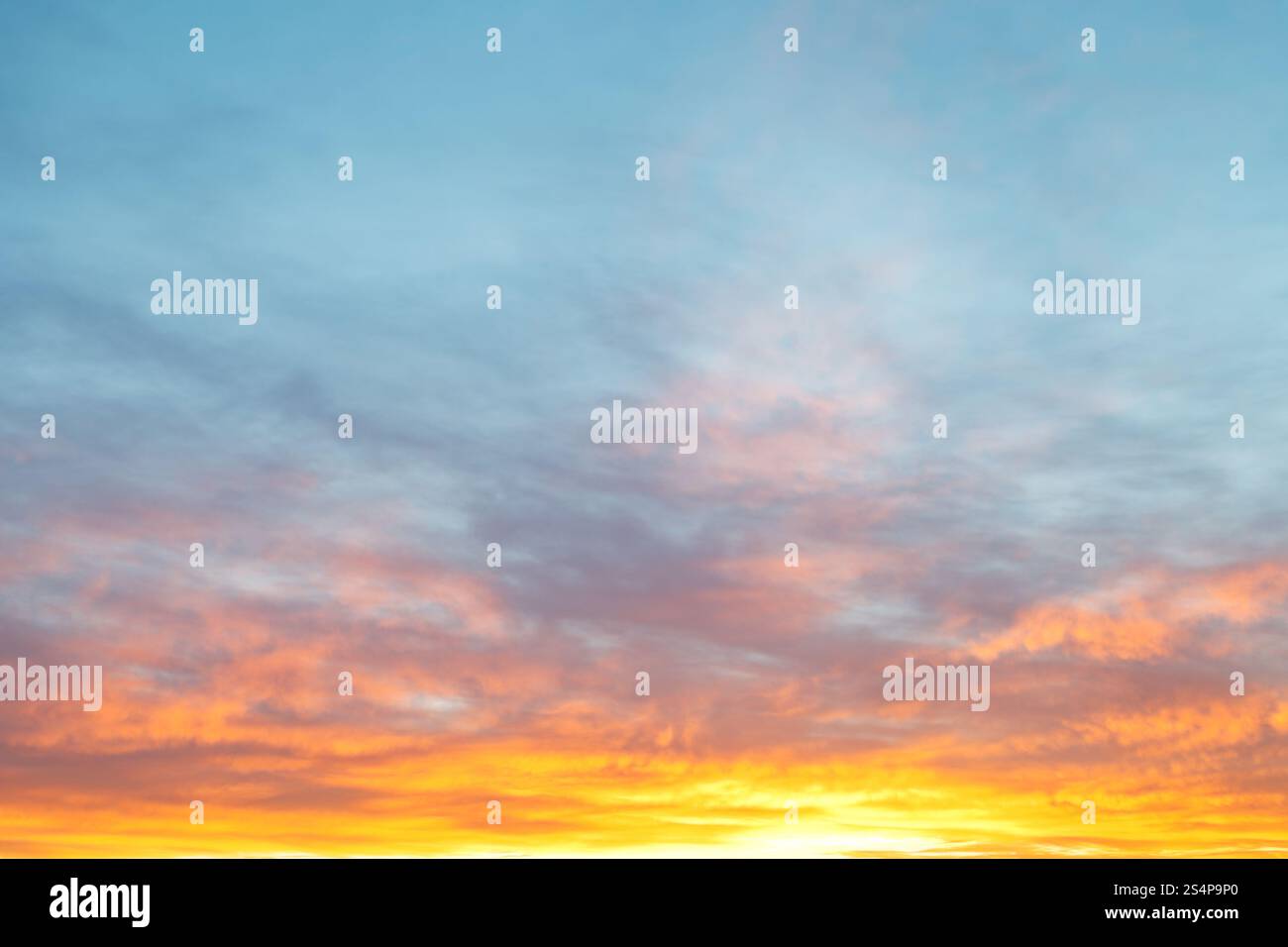 light blue morning sky over pastel pink and yellow sunrise clouds in ...