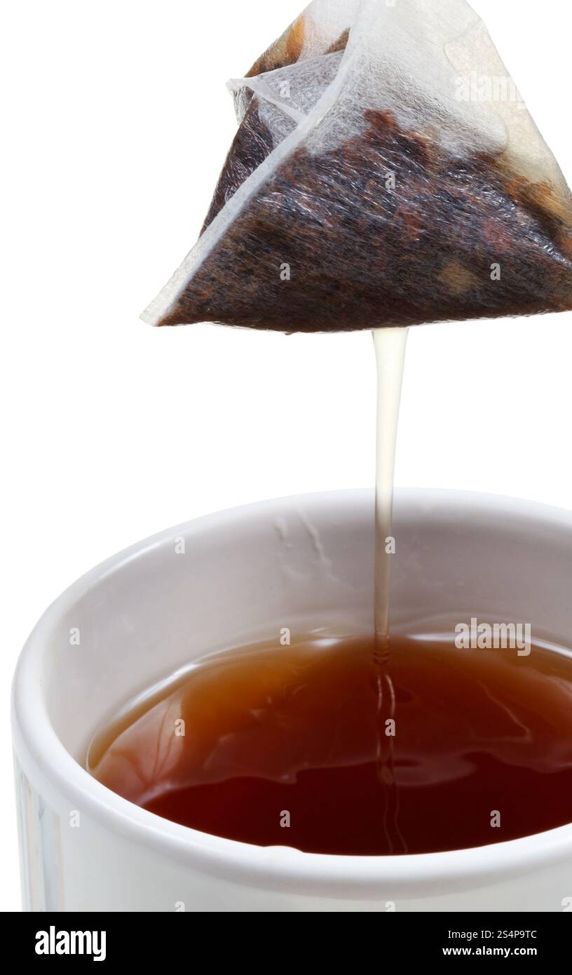 removing of tea bag from mug with brewing tea close up isolated on ...
