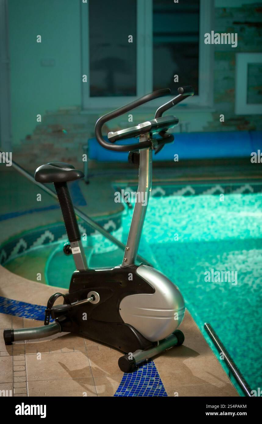 Exercise bike standing at swimming pool Stock Photo - Alamy