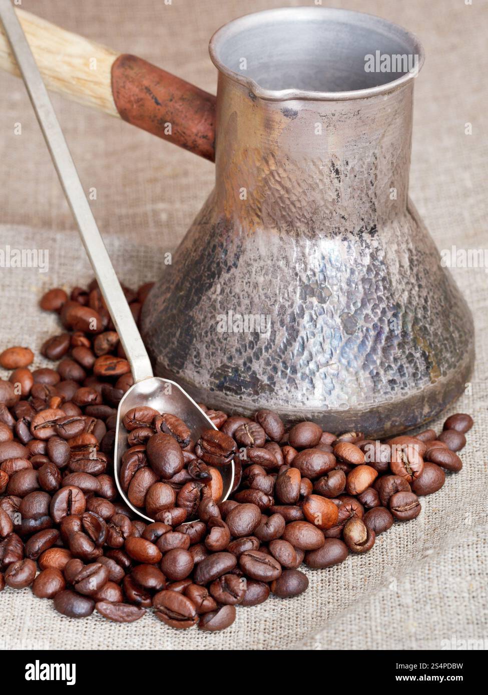 roasted coffee beans and copper coffee pot close up on sacking Stock ...