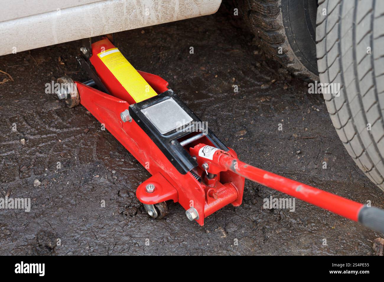 seasonal replacement of tires with jack outdoors - lifting car by jack ...