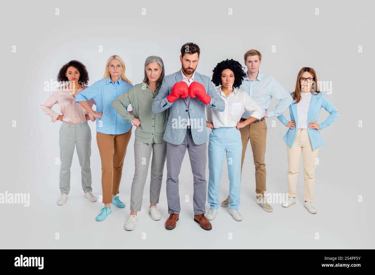 Confident business team standing together on a grey background ...