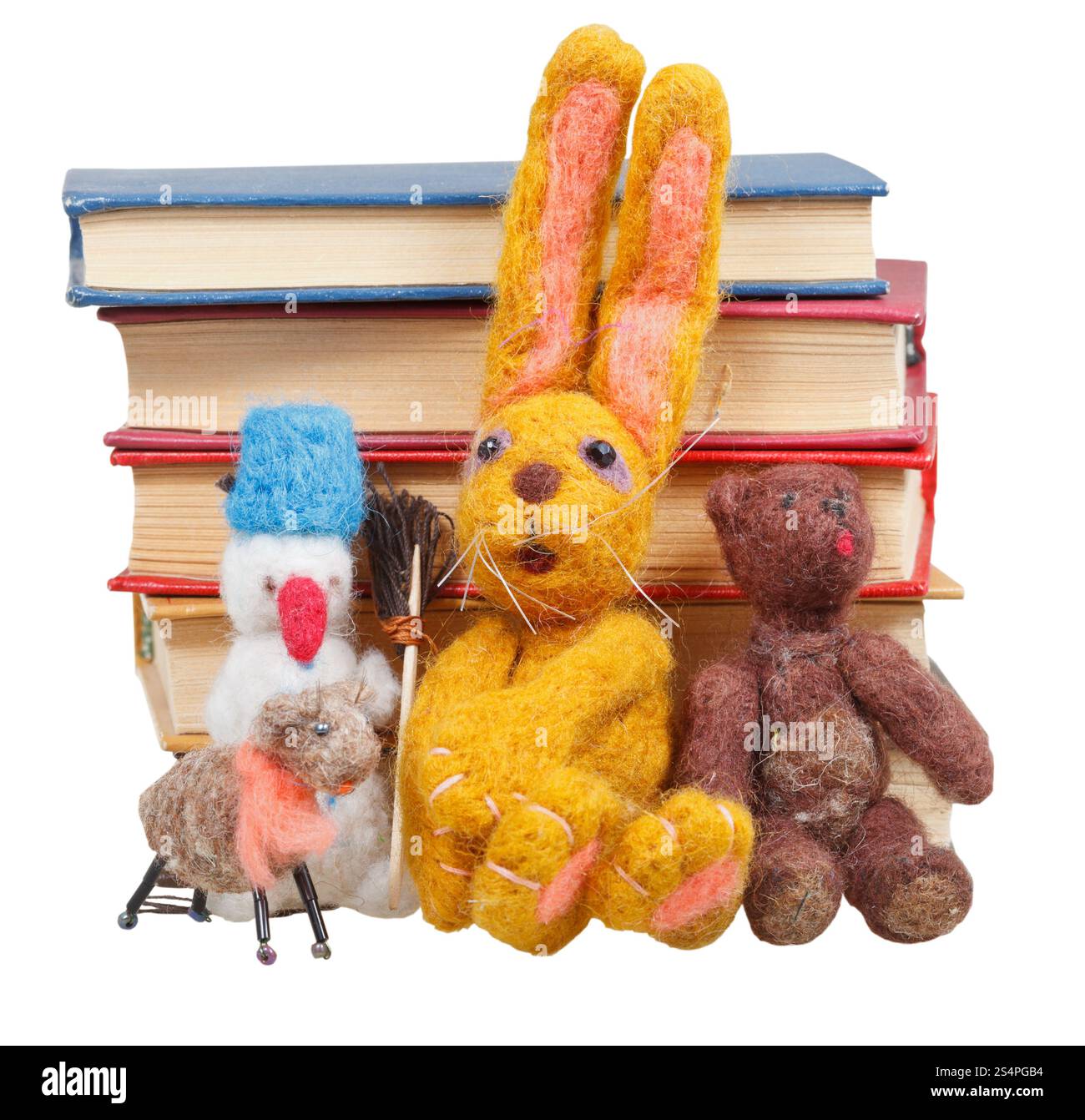 felt soft toys near stack of books isolated on white background Stock ...