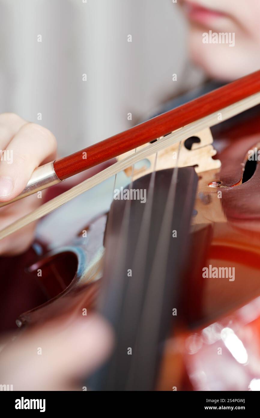 child plays on fiddle by bow close up Stock Photo - Alamy