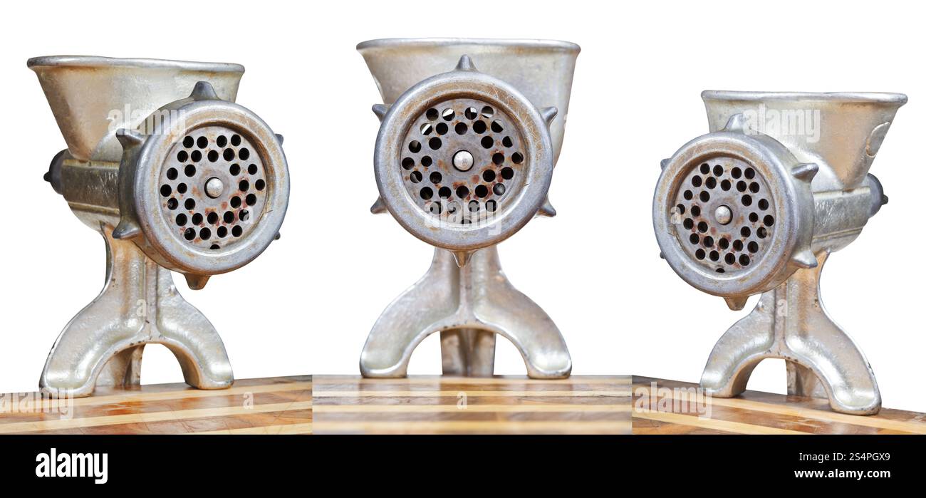 set old iron meat mincers mounted on wooden table isolated on white ...