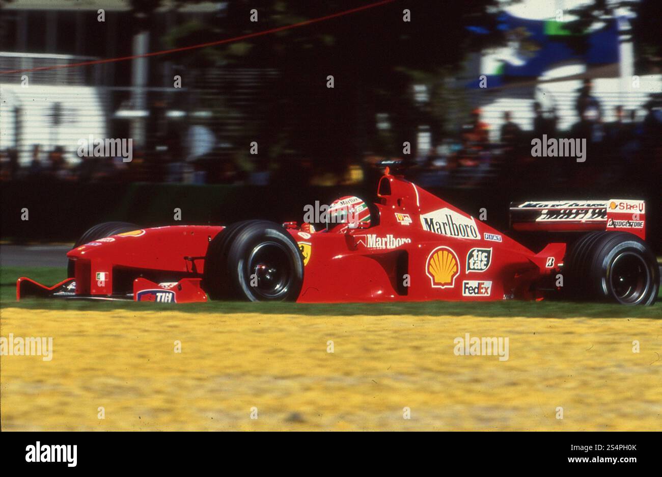 British motorsports F1 racing driver Eddie Irvine on Ferrari F1 car ...