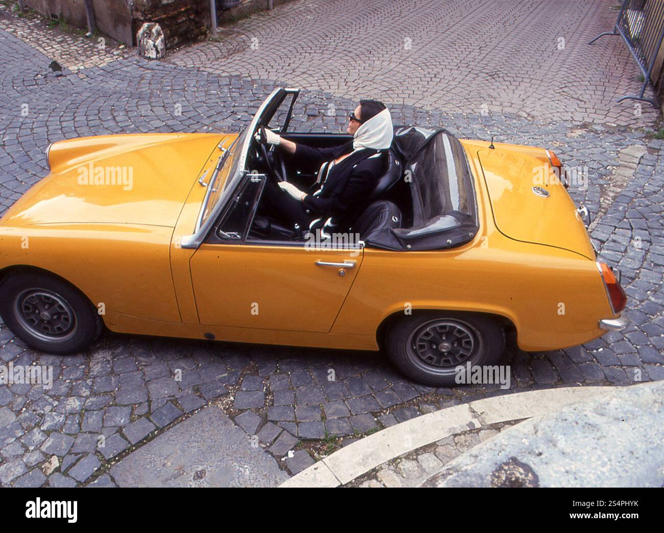 Woman driving a British MG Midget car, Italy 1999 Stock Photo - Alamy