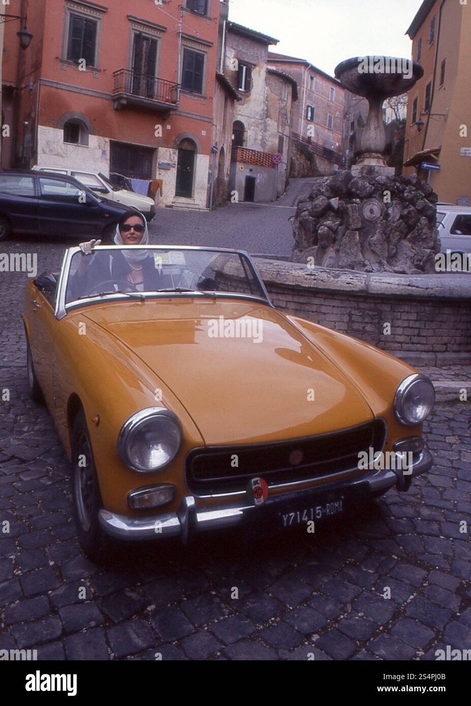 Woman driving a British MG Midget car, Italy 1999 Stock Photo - Alamy