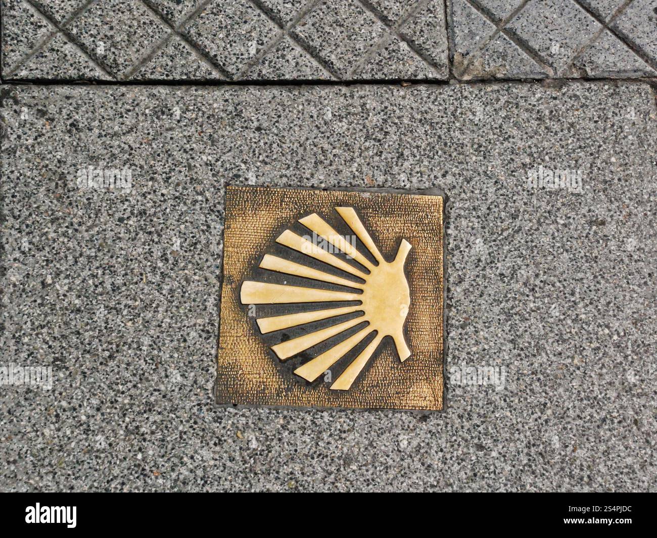 marker in the pavement indicates the route of the Way of St. James ...