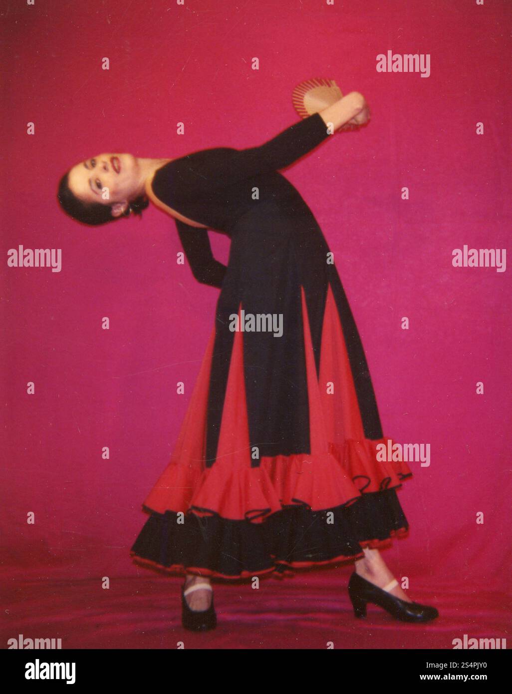 Girl in traditional Spanish Flamenco outfit performing a position ...