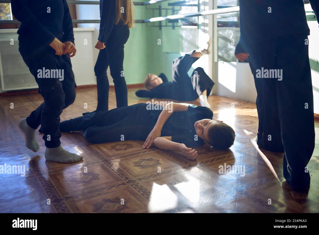 group of pre-teens perform a teacher's task during an acting class ...