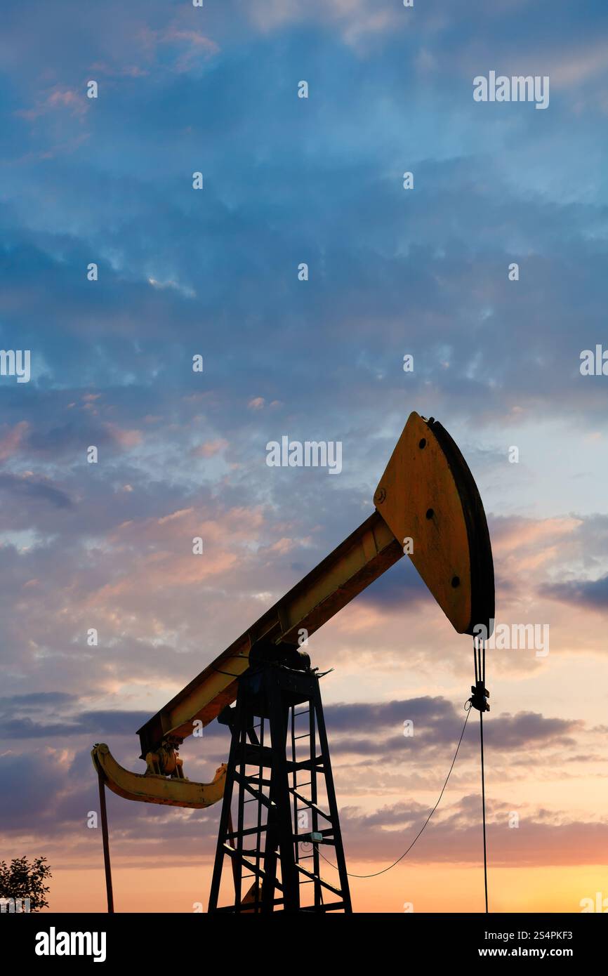 pump jack extracts oil in Caucasus region at summer sunset Stock Photo ...