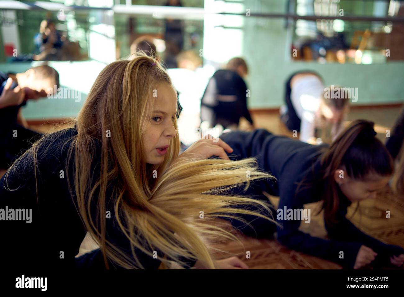 group of pre-teens perform a teacher's task during an acting class ...
