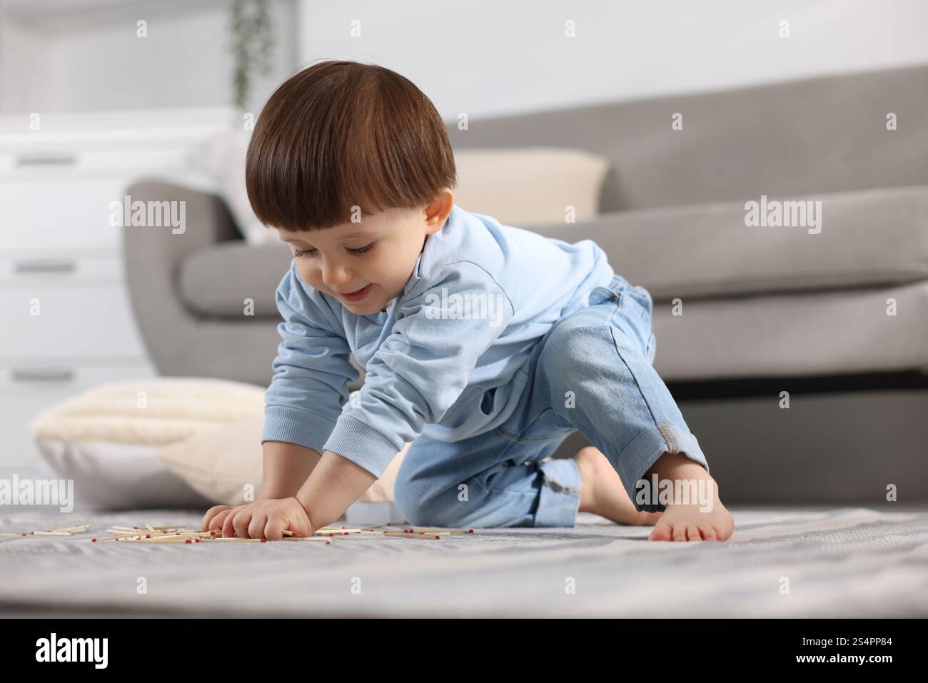 Little boy playing with matches at home. Child in danger Stock Photo ...