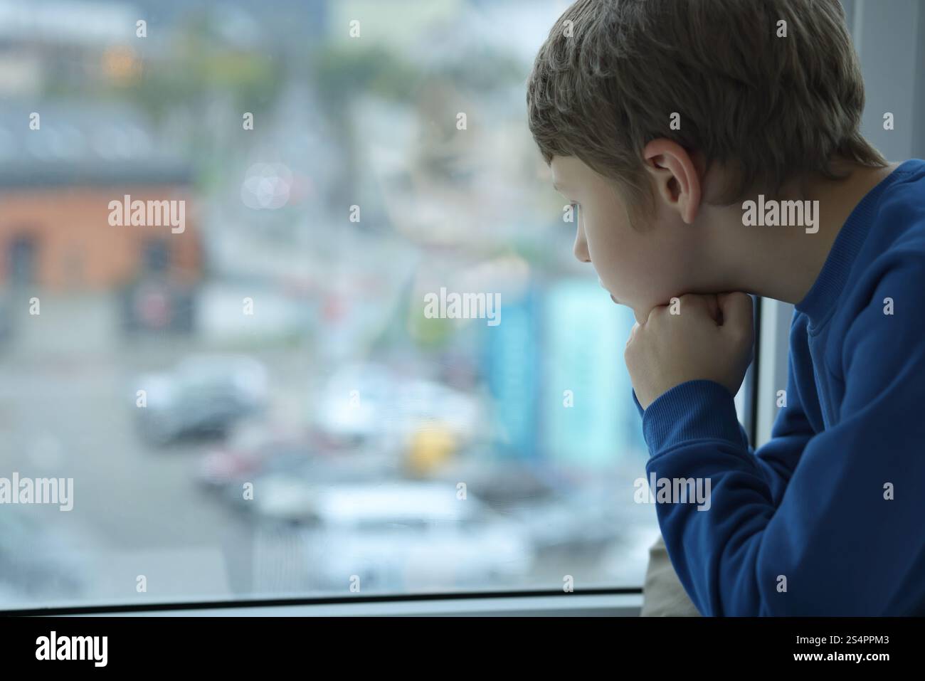 Autism concept. Lonely little boy near window at home, space for text ...