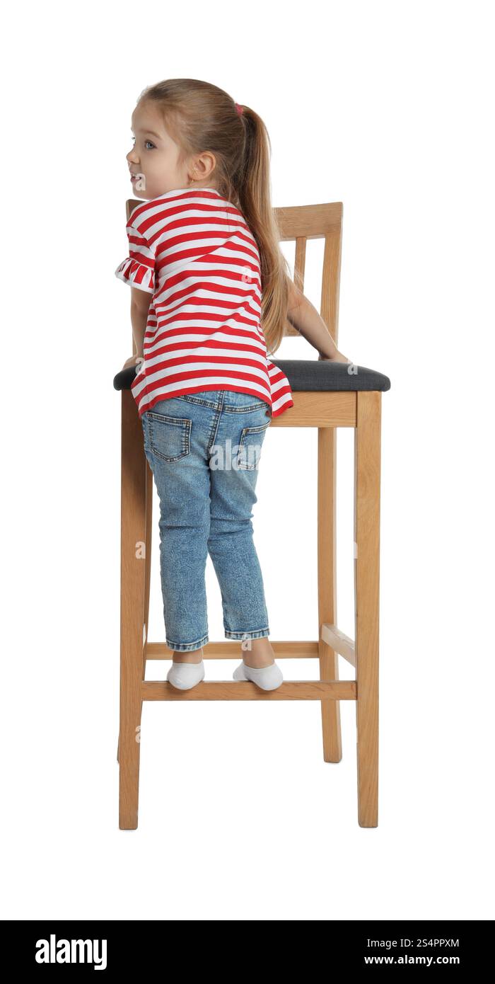 Little girl standing on stool against white background Stock Photo - Alamy