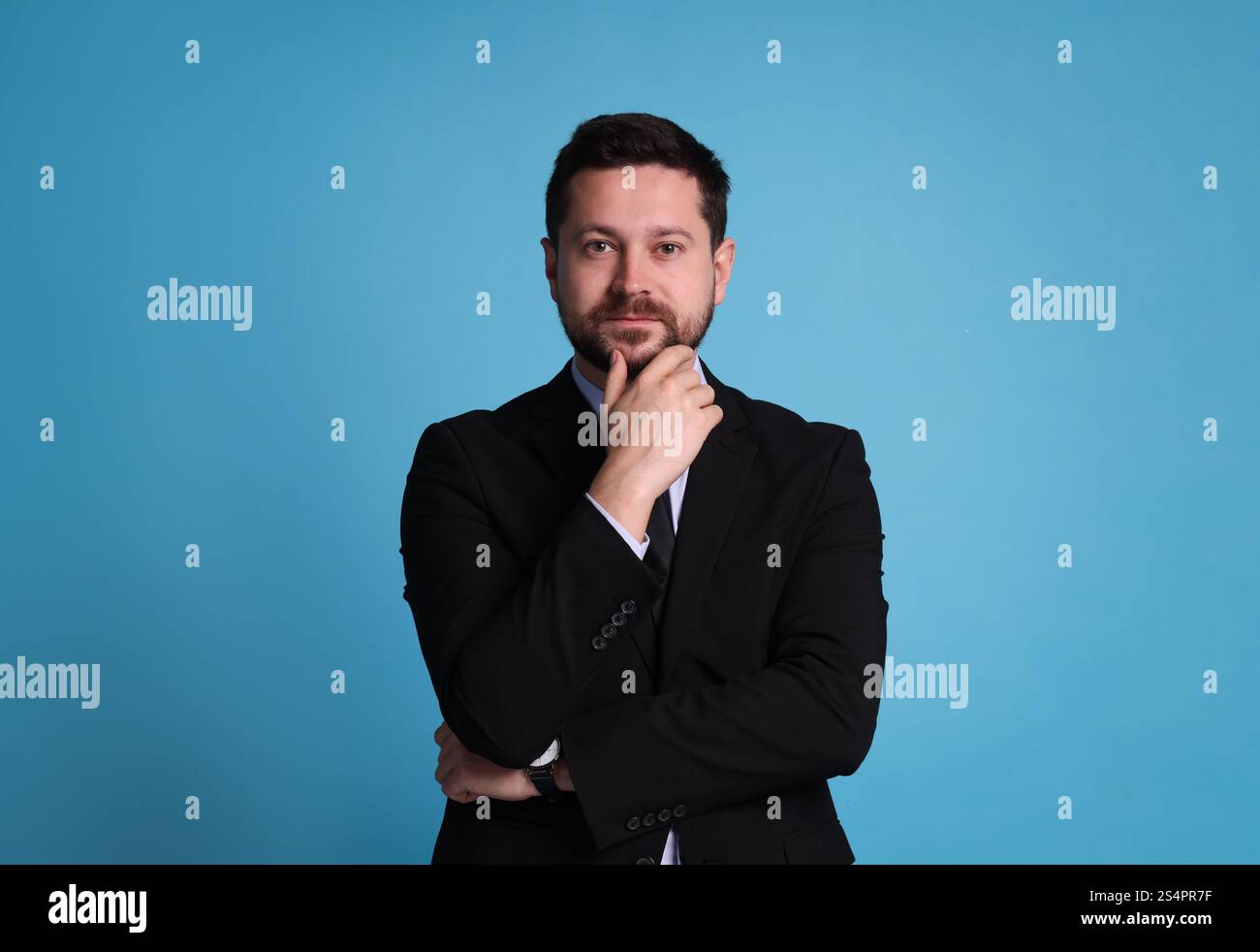 Portrait of banker on light blue background Stock Photo - Alamy