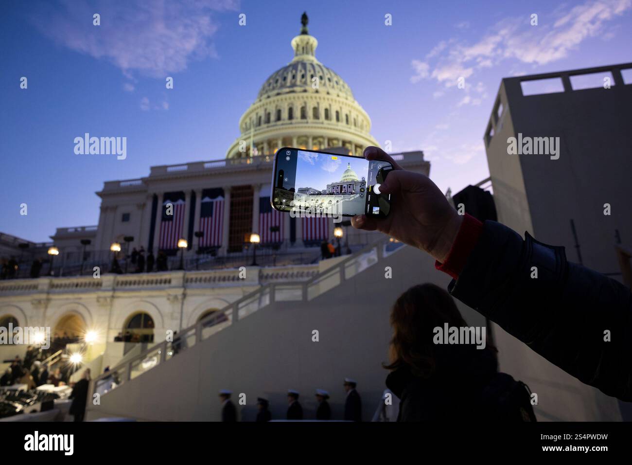 A journalist takes a photograph of the U.S. Capitol building during a ...