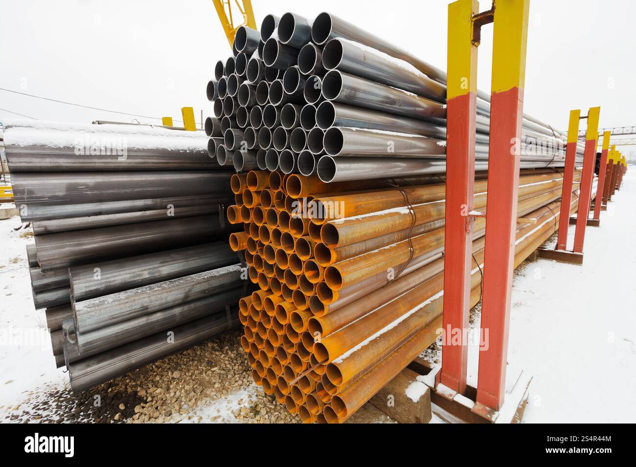 pile of construction pipes in outdoor warehouse in winter Stock Photo ...