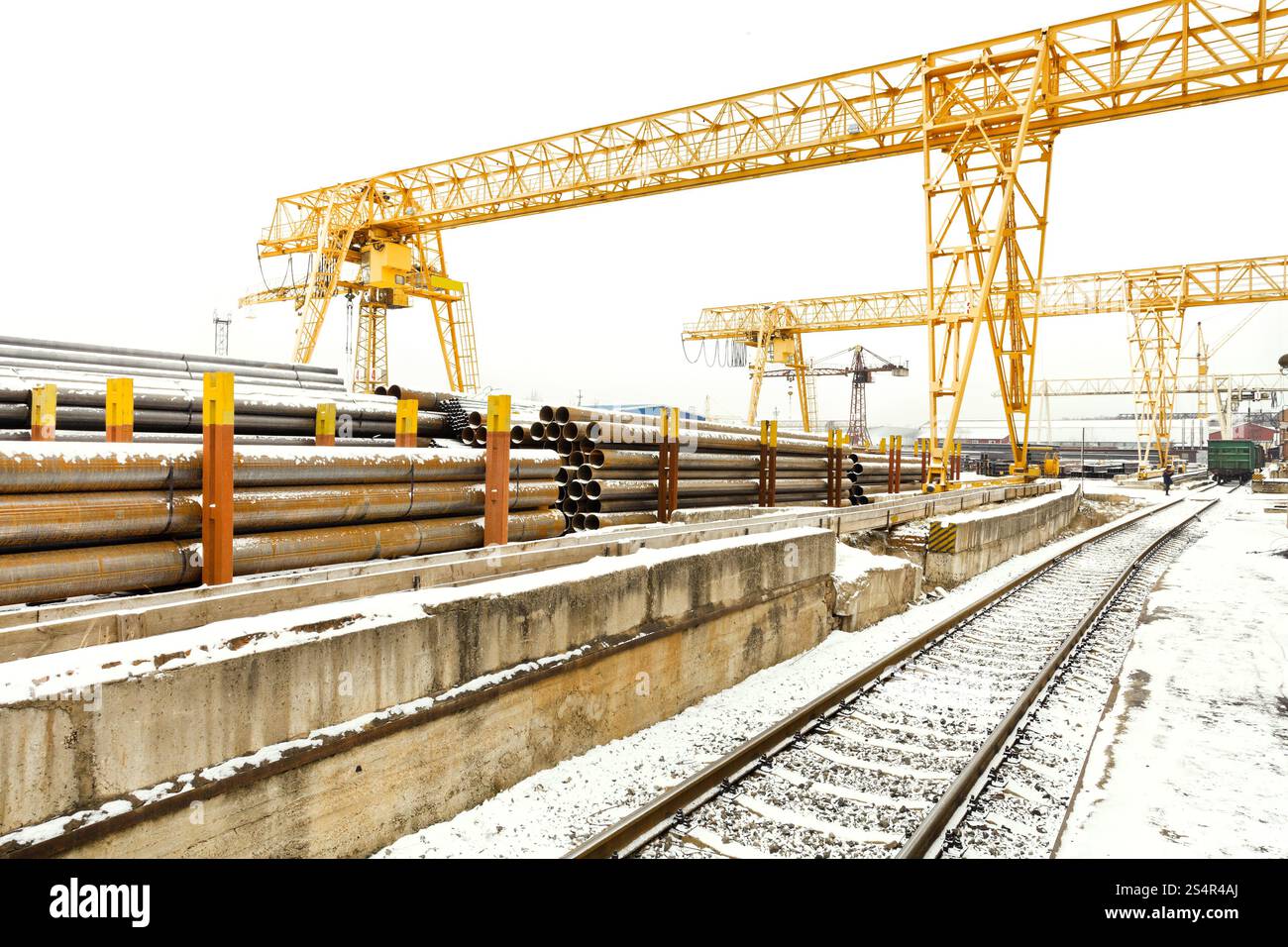 overhead cranes over railroad in metal pipe outdoor warehouse Stock ...